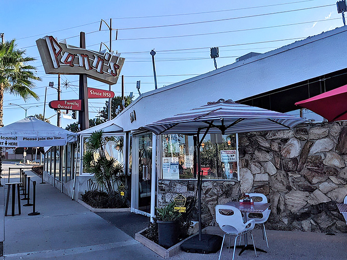 That iconic angular roof and neon sign aren't just eye-catching—they're a time portal to mid-century Los Angeles when optimism came supersized.