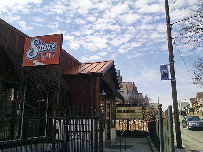 The Shore Diner's rustic wooden exterior and vintage orange sign stand as a beacon of breakfast hope against the Pennsylvania sky. Come hungry, leave happy!