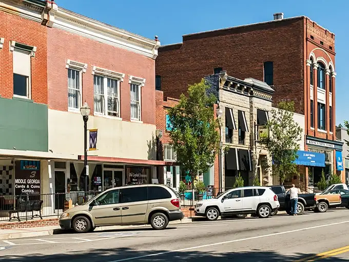 Downtown Milledgeville's vintage Coca-Cola sign isn't retro chic—it's the real deal, standing sentinel over Wayne Street like a carbonated time capsule.