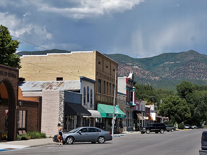 Downtown Paonia sits like a movie set against the dramatic backdrop of mountains, where storm clouds gather but never dampen the town's charm.