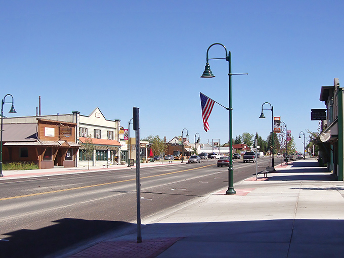 Main Street Driggs – where Norman Rockwell meets mountain majesty. Those green lampposts and American flags aren't just decoration; they're a promise of small-town authenticity.