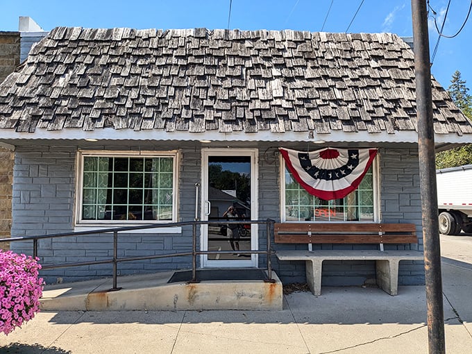 The weathered wooden shingle roof and patriotic bunting tell you everything – this isn't just a restaurant, it's a slice of Americana waiting to be savored.