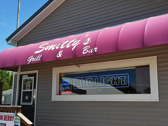 The pink awning of Smitty's beckons like a neon promise in rural Illinois—small-town charm with big-time flavor waiting just beyond that door.