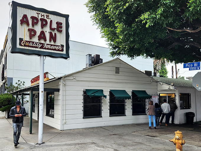
The unassuming white building with its vintage sign promises "Quality Forever" – a bold claim that The Apple Pan has somehow managed to keep for decades.
