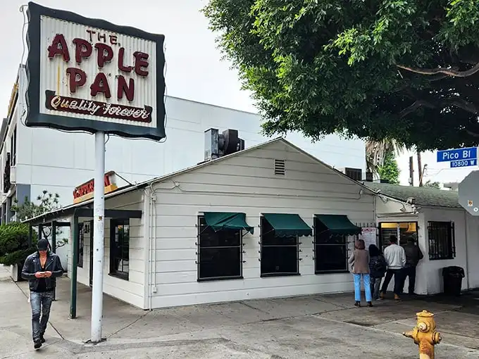 The unassuming white building with its vintage sign promises "Quality Forever" – a bold claim that The Apple Pan has somehow managed to keep for decades.