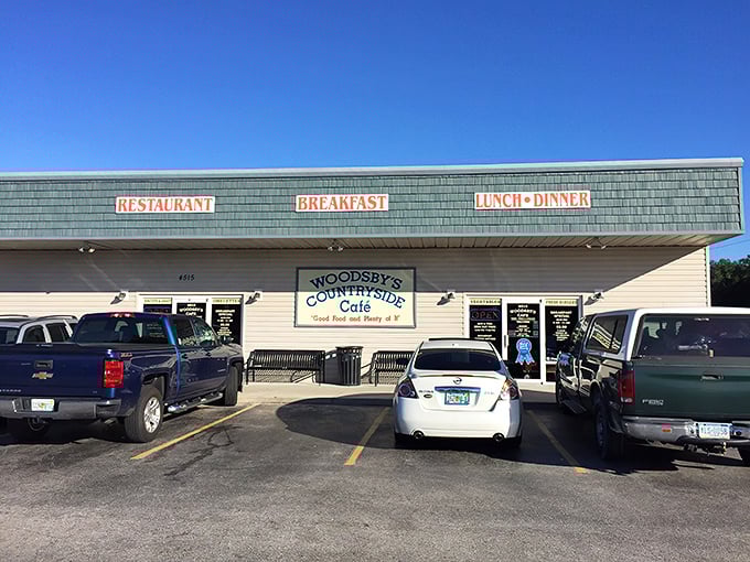 The unassuming exterior of Woodsby's Cafe might not scream "culinary destination," but locals know this blue-roofed treasure holds comfort food gold inside.