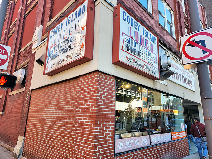 The iconic red and white sign beckons hungry travelers like a culinary lighthouse. "Famous Coney Island HOT DOGS" isn't just advertising—it's a promise kept for generations.