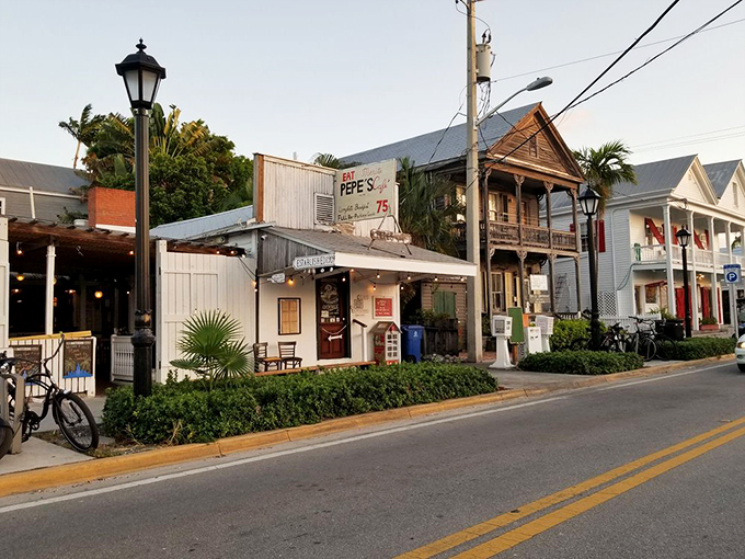 The white picket fence and vintage lamp post aren't just charming decor—they're time machines to Old Florida, where bicycles outnumber BMWs.
