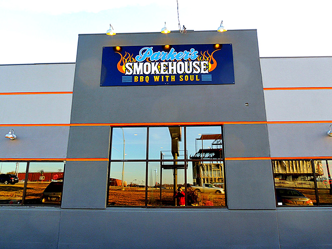 The blue neon sign proclaiming "BBQ WITH SOUL" isn't just marketing—it's a mission statement that Parker's Smokehouse delivers on with every smoky bite.