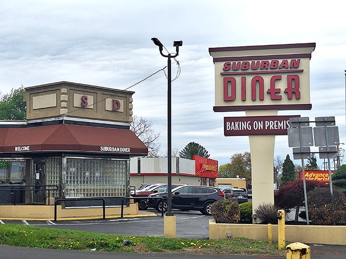 The iconic Suburban Diner sign promises "BAKING ON PREMIS" – a charming typo that somehow makes the anticipation of fresh-baked goods even more endearing. 