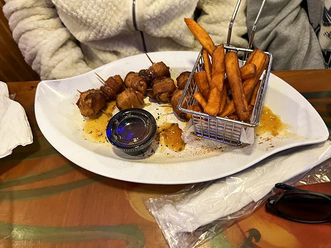 This isn't just a plate of bacon-wrapped delights—it's proof that sometimes the best things in life come in small packages with a side of sweet potato fries.