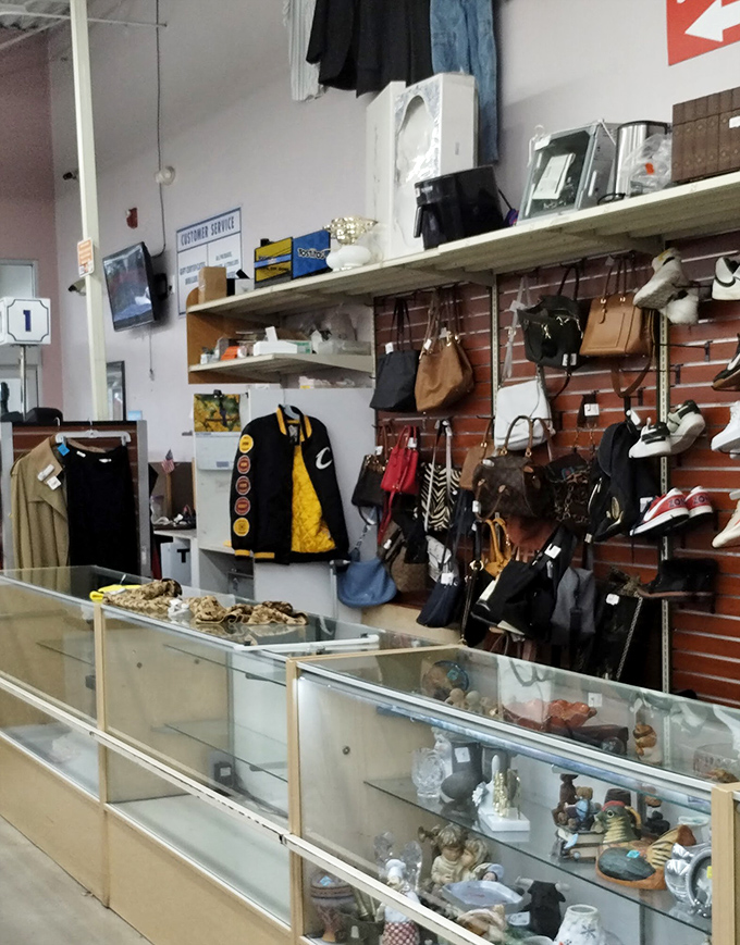 The accessories section – a museum of practical art where vintage handbags and barely-worn heels await their next adventure.
