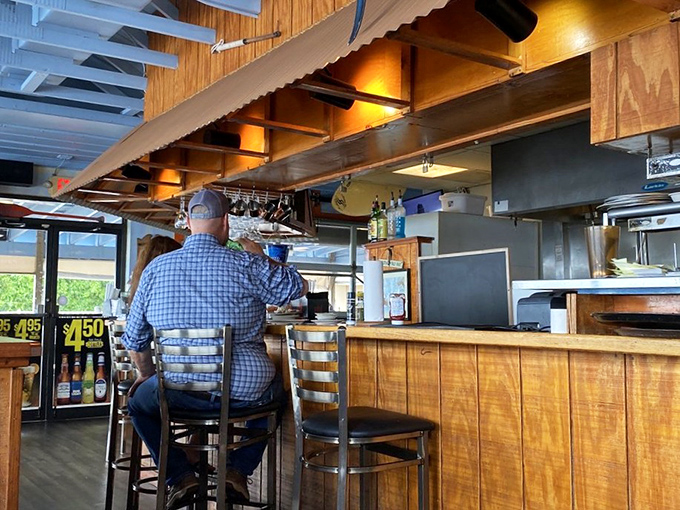 The bar area—where locals perch like seasoned pelicans, knowing exactly where the good stuff is found.