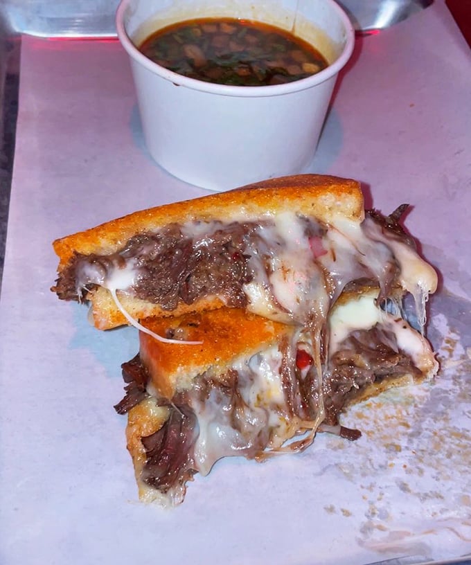 This isn't just a grilled cheese—it's a transformative experience with birria's rich flavors. The soup alongside is liquid gold.