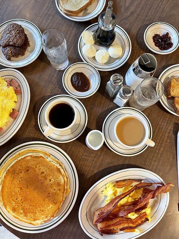 A breakfast spread that says "cancel your lunch plans"—pancakes, eggs, bacon, and coffee creating the ultimate morning symphony. 