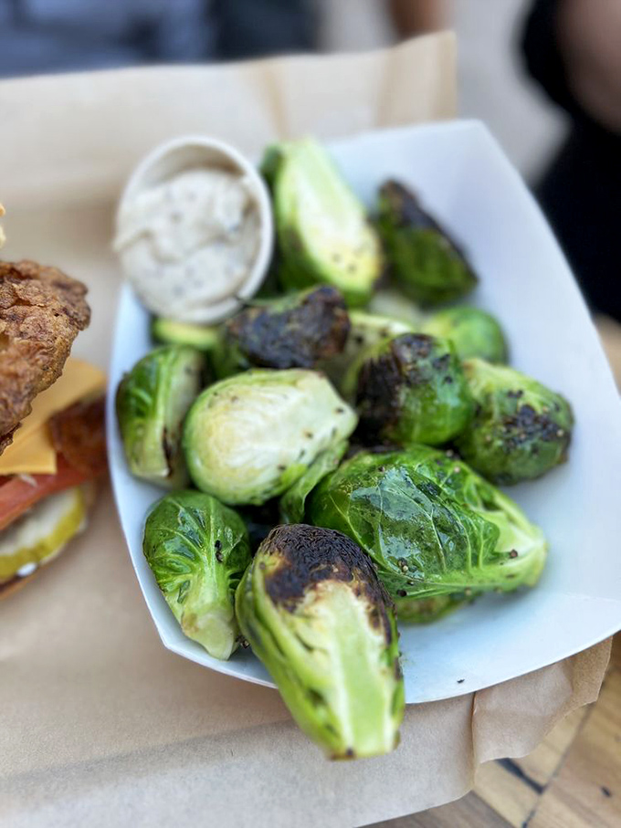 Brussels sprouts that could convert even the most dedicated vegetable skeptic—roasted to caramelized perfection with a side of creamy dipping sauce.
