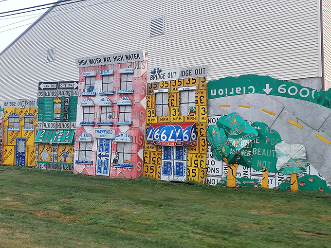 Neighborhood watch, sign-style! These colorful building facades create a miniature Main Street from materials that once lined actual streets—meta-architecture at its finest.