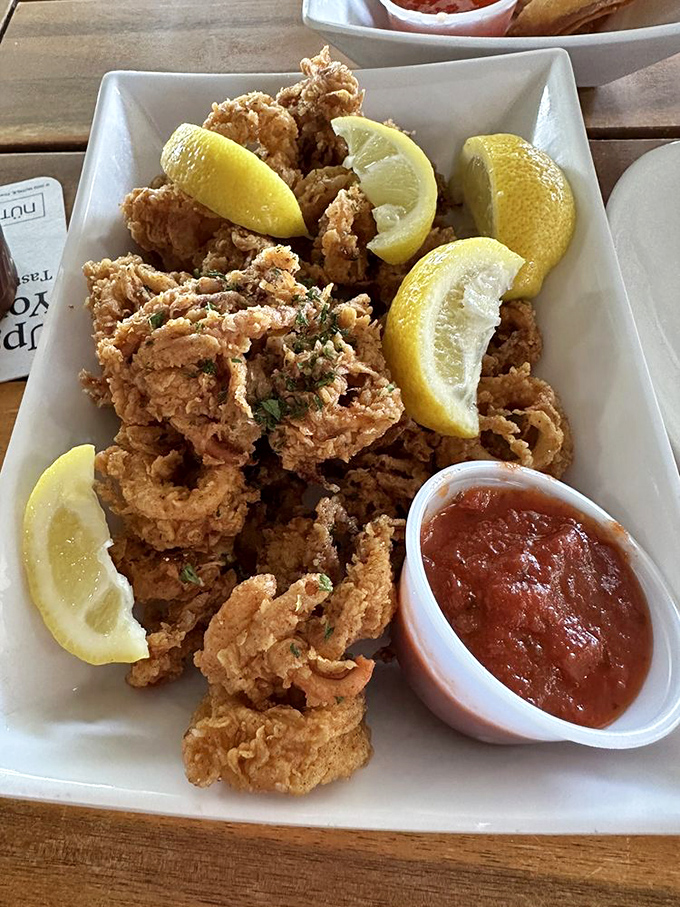 Fried calamari that's crispy, not chewy—the unicorn of seafood appetizers—with lemon wedges standing by for that perfect citrus zing.