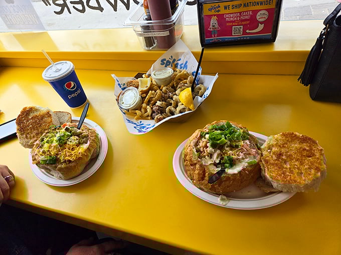 A spread worthy of celebration – where bread bowls meet calamari and fries in a yellow-tabled feast that defines California coastal dining.