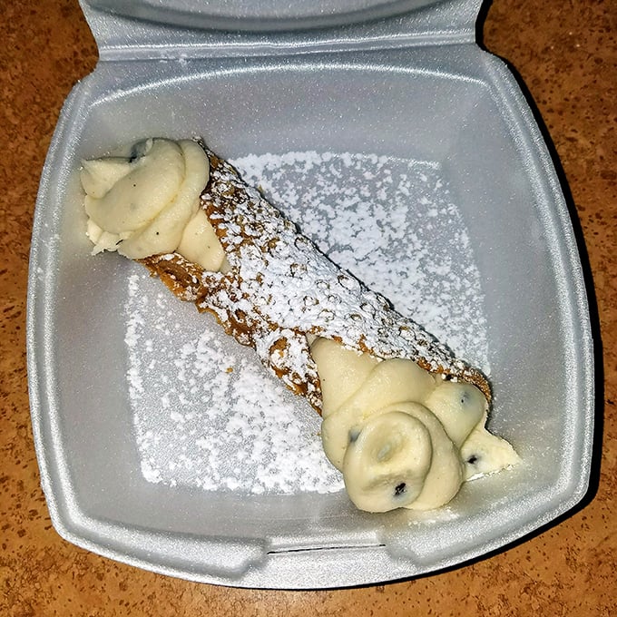 The cannoli—crisp shell, creamy filling, and a dusting of powdered sugar. Dessert perfection that makes you want to speak with your hands.