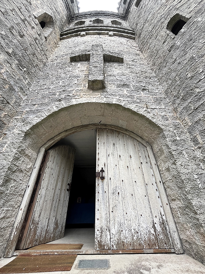 The massive wooden doors, weathered by Florida's salt air, open to reveal a cross embedded in the stone—your first hint this isn't your typical castle.