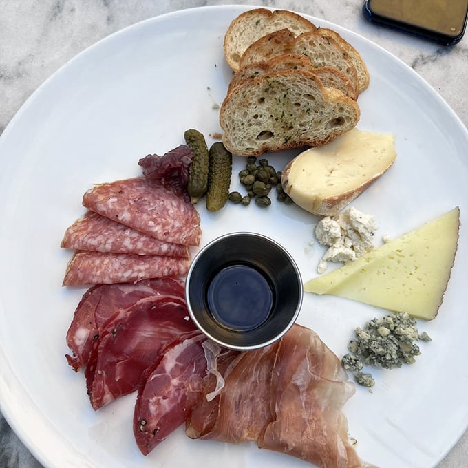 A charcuterie board so perfectly arranged it seems criminal to disturb it – but disturb it you must, because these flavors demand attention.