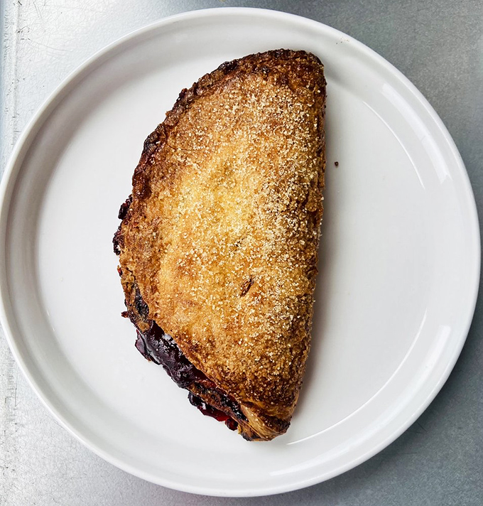 Half moon, full flavor—this fruit-filled hand pie proves that the best things in life come wrapped in buttery, sugar-dusted pastry.
