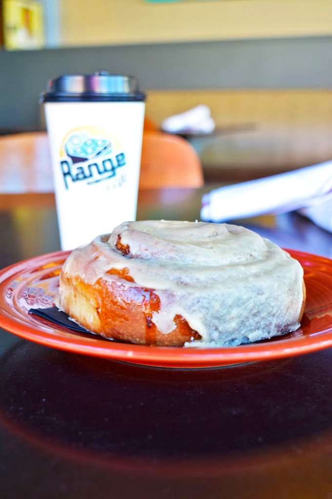 The cinnamon roll that launched a thousand road trips—a spiral of sweet dough wearing its cream cheese frosting like a decadent crown.