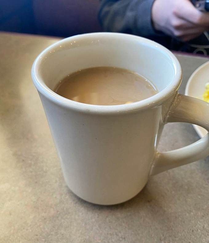 The humble diner coffee mug—holding what might not be the world's finest brew, but definitely the perfect companion to everything else on the menu.