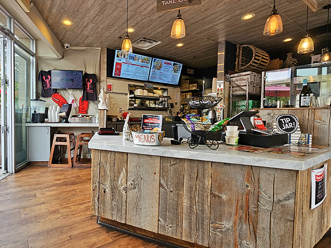 Behind every great seafood spot is a counter that tells stories. This driftwood-inspired design whispers tales of ocean journeys while staff prepare maritime treasures.