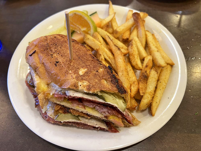 This Cuban sandwich with seasoned fries isn't just lunch—it's a vacation for your taste buds, no passport required.