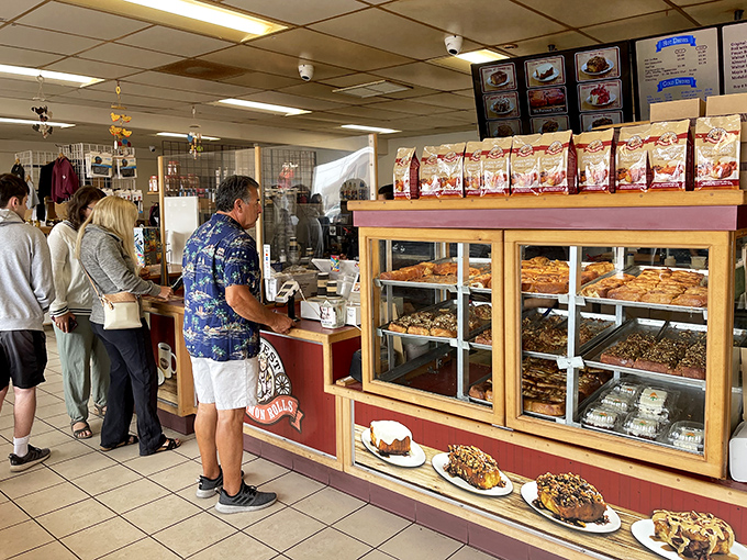 The display case—where cinnamon roll dreams become reality. That moment of pointing and saying "that one" feels like winning the lottery.