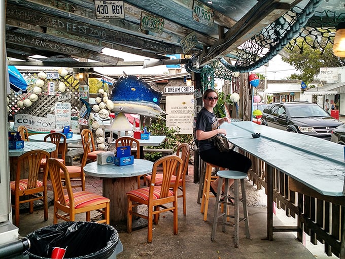 Nautical whimsy meets practical dining. Fishing nets overhead, mismatched chairs below—this isn't decoration, it's authentic Keys character.