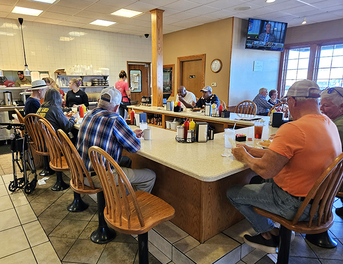 The counter seating—where farmers, truckers, and road-trippers share coffee, conversation, and the unspoken brotherhood of good food appreciation.