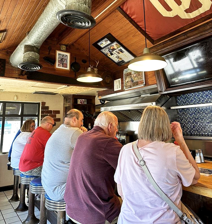 The counter seating isn't just practical—it's communal. Strangers become friends when united by the pursuit of burger bliss.