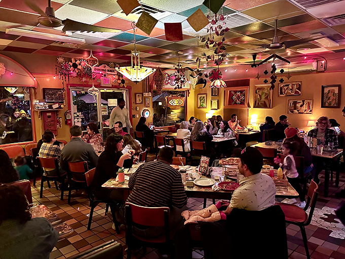The dining room buzzes with the energy of happy eaters under a ceiling festooned with colorful decorations – proof that good food creates instant community.