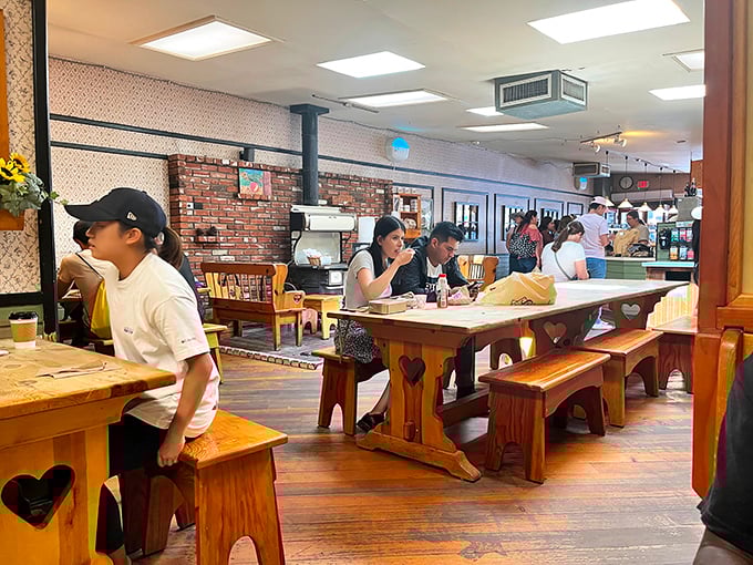 Heart-carved wooden tables hosting pilgrims on the path to pie perfection – comfort food deserves comfortable seating.