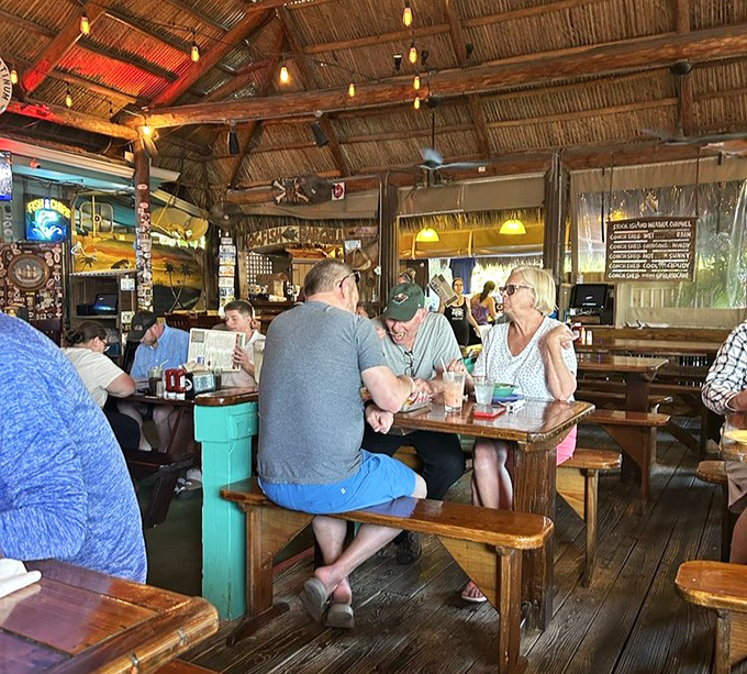Where locals and visitors mingle over cold drinks and fresh catches—the universal language of good food bridging all differences.