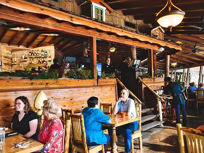 Multi-level dining areas create intimate spaces within the grand lodge, where conversations flow as freely as the cocktails.