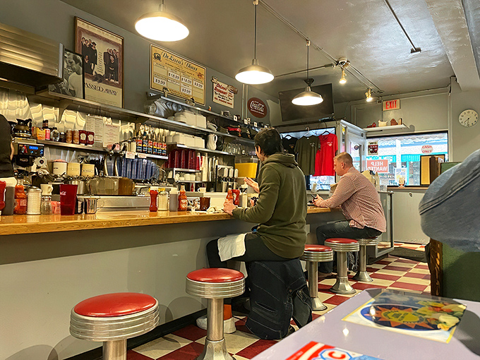 Counter culture at its finest—red stools and checkerboard floors create the classic American diner experience Pittsburgh loves.