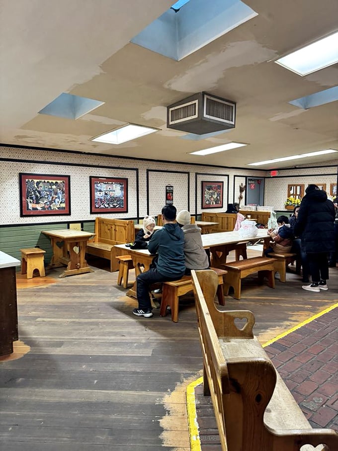 The wooden booths and benches aren't just seating—they're front-row tickets to the best show in town: your imminent pie experience.