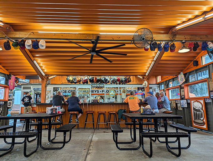 Regulars know the best seats in the house come with decades of stories hanging from the ceiling—baseball caps marking time like rings in a tree.