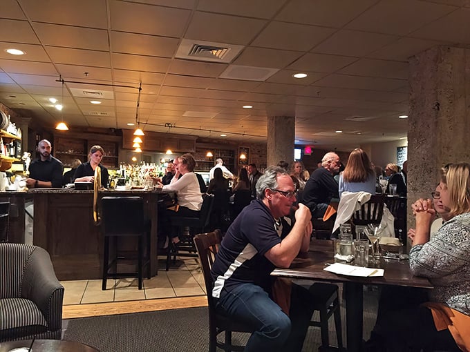 The bar area buzzes with the energy of people who've discovered something special – notice nobody's looking at their phones? That's the power of good food.