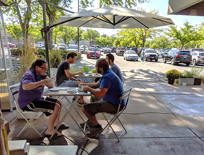Outdoor dining that turns a parking lot view into a European-style café experience. Proof that good company and better pastries transform any space.