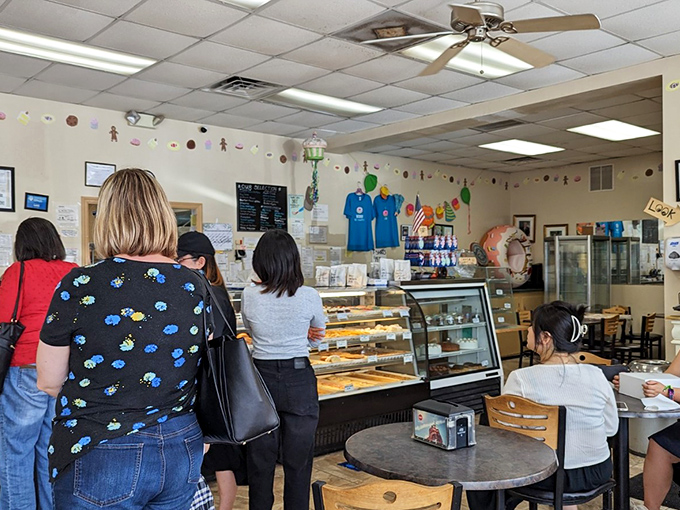 The universal language of anticipation. These customers know that patience isn't just a virtue—it's the price you pay for pastry perfection.