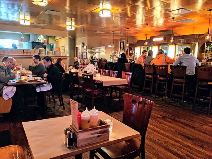 As evening falls, the restaurant transforms – warm lighting bathes wooden tables while diners lean in, sharing stories and stealing bites from each other's plates.