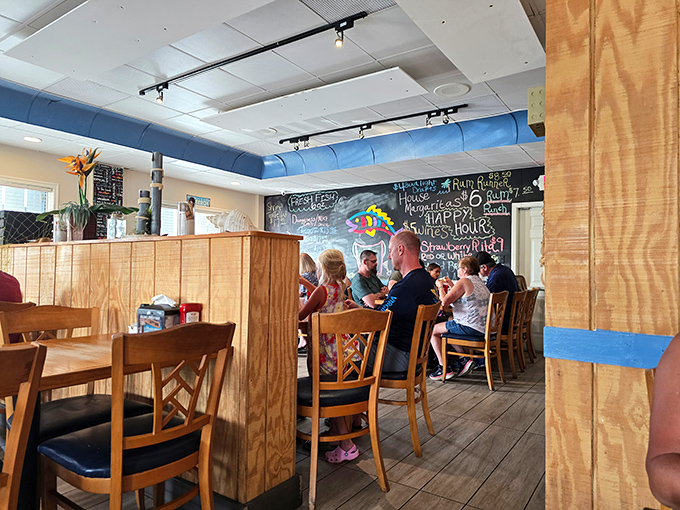 Cozy wooden booths and a chalkboard wall create that neighborhood joint feeling. The kind of place where "everybody knows your name"—or at least your favorite fish dish.