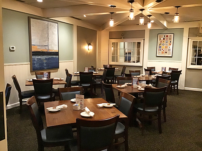 The dining room balances nautical charm with practical comfort—those blue-gray walls practically whisper tales of Atlantic adventures between bites.