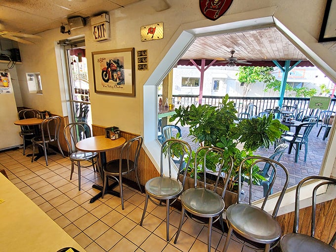 Plants frame the outdoor view in this cozy corner where conversations flow as easily as the Florida breeze through open windows.