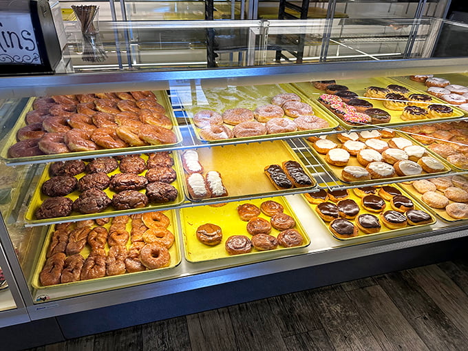 The donut display case – where grown adults press their noses against the glass like kids at a toy store window.